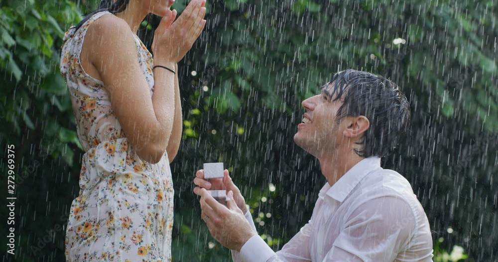 Portrait of young handsome man is making a proposal of marriage to his ...