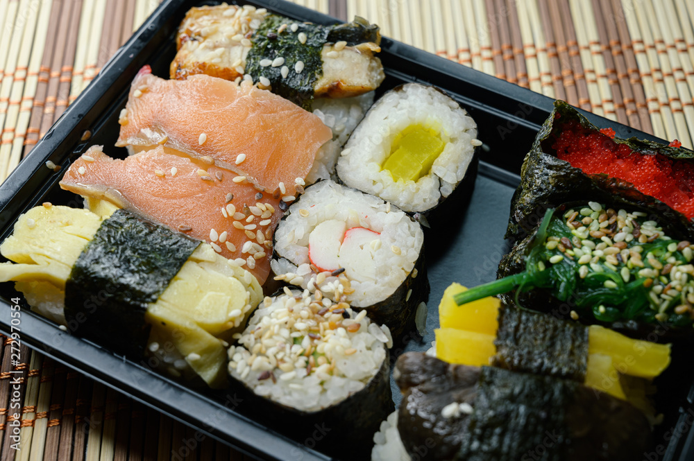 Set of various rolls in black plastic box. Rolles collection with crab ...