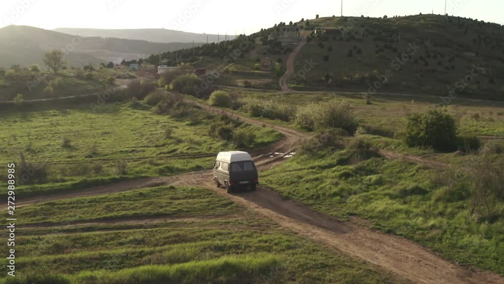 Shooting from the air tourist van car traveling through agricultural ...