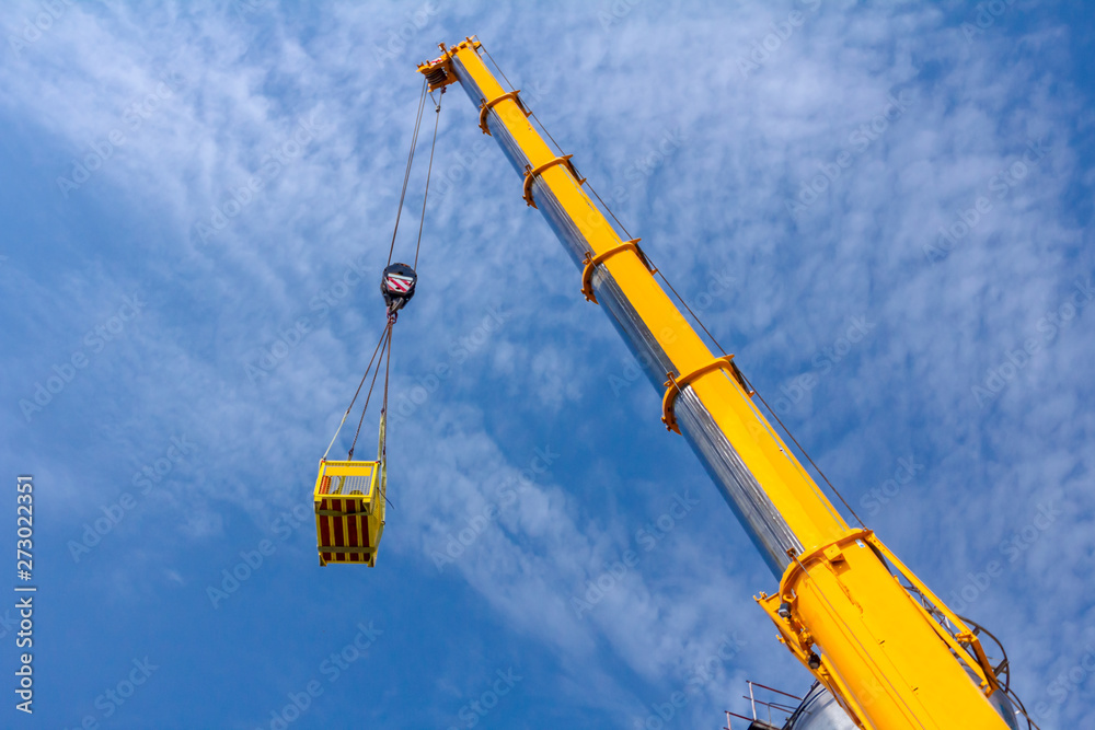 Mobile crane is lifting cargo in work platform, basket Stock Photo ...