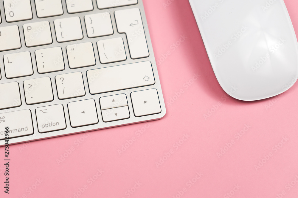 Pink office desk background with computer keyboard and other office ...