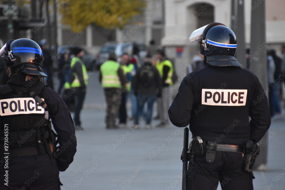 Helmeted police officers photographed from behind during a protest ...