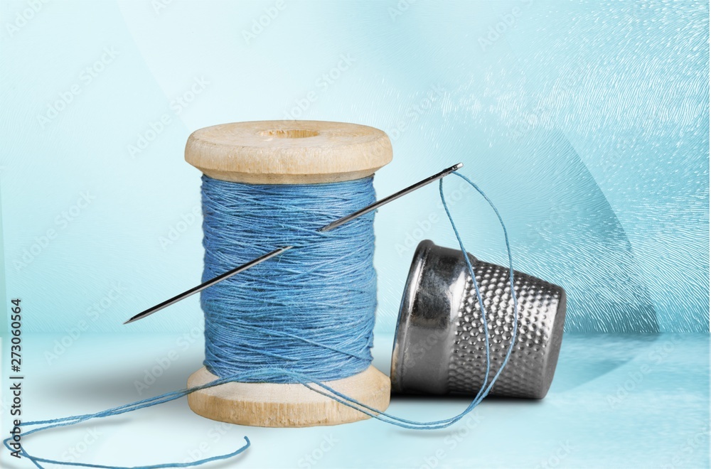 Spool with needle and thimble isolated on white Stock Photo | Adobe Stock