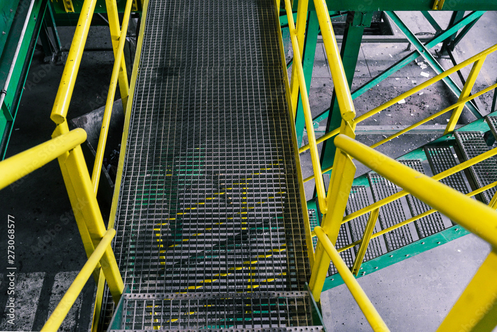 The metal ladder painted in green and yellow colors. Iron ladder in an ...