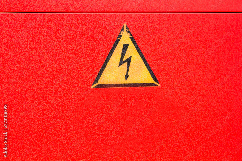 yellow caution high voltage warning sign on bright red background Stock ...