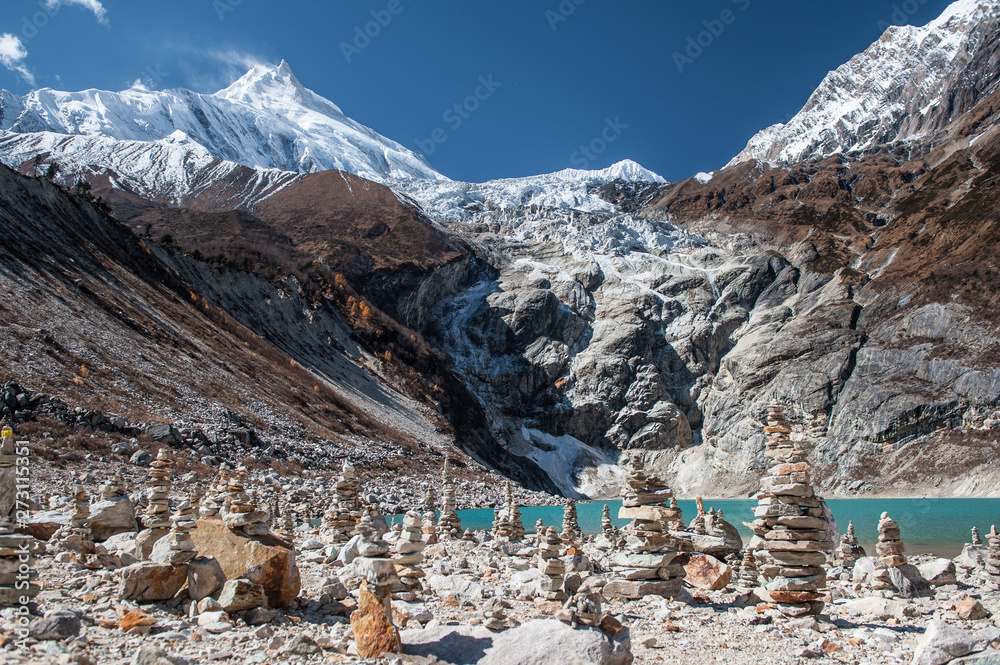 Stonemen and a beautiful view of Manaslu mountain range, Birendra lake ...