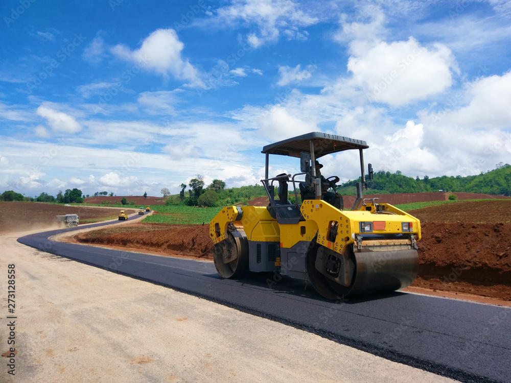 Road rollers building the new asphalt road and working on new road ...