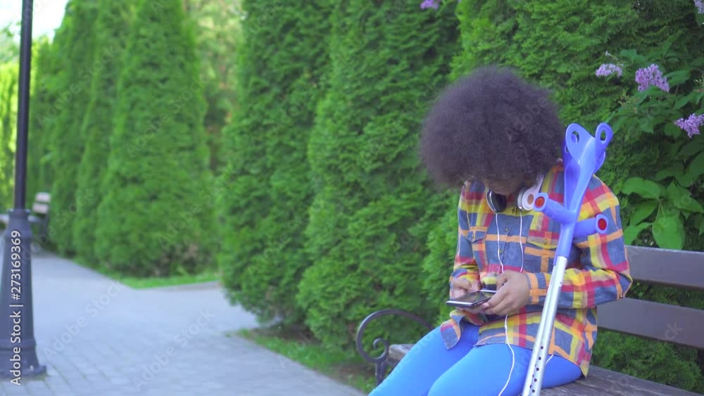 african american woman with an afro hairstyle with a broken leg with ...