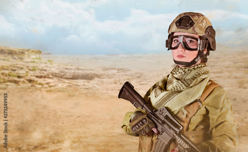 Fully equipped military soldier woman holding an automatic rifle M16 on ...