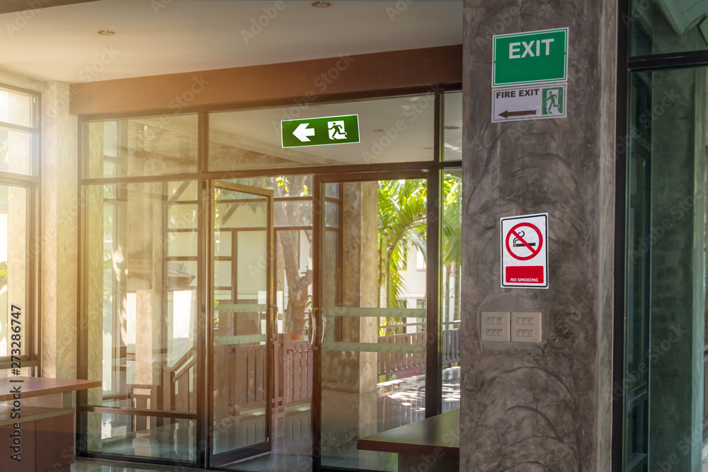 Green emergency exit sign and label no smoke in rest corner showing the ...