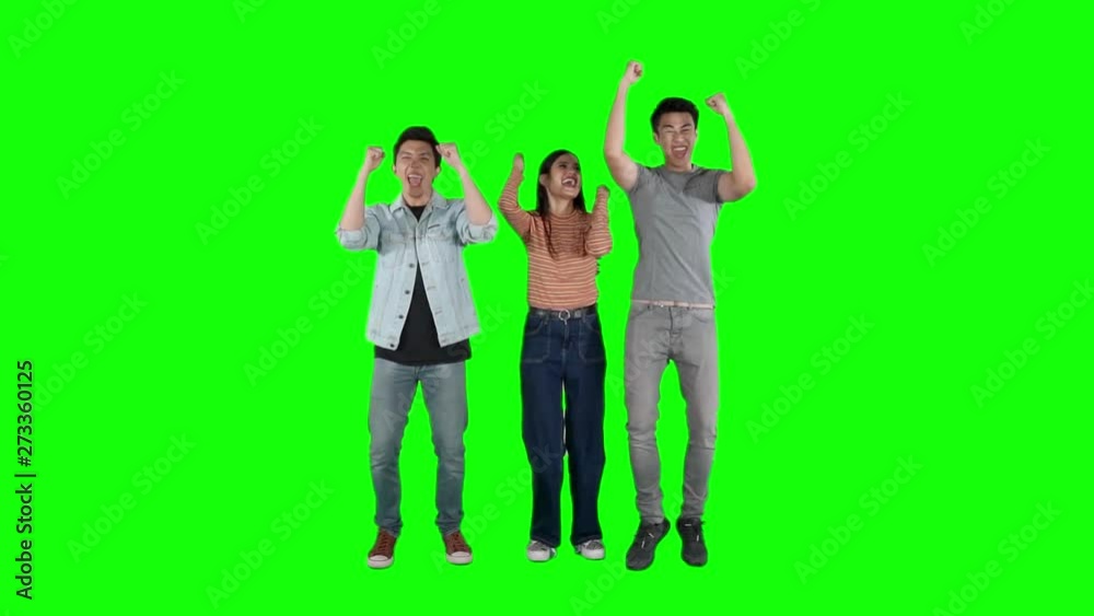 Slow motion of group of friends jumping together in the studio. Shot in ...