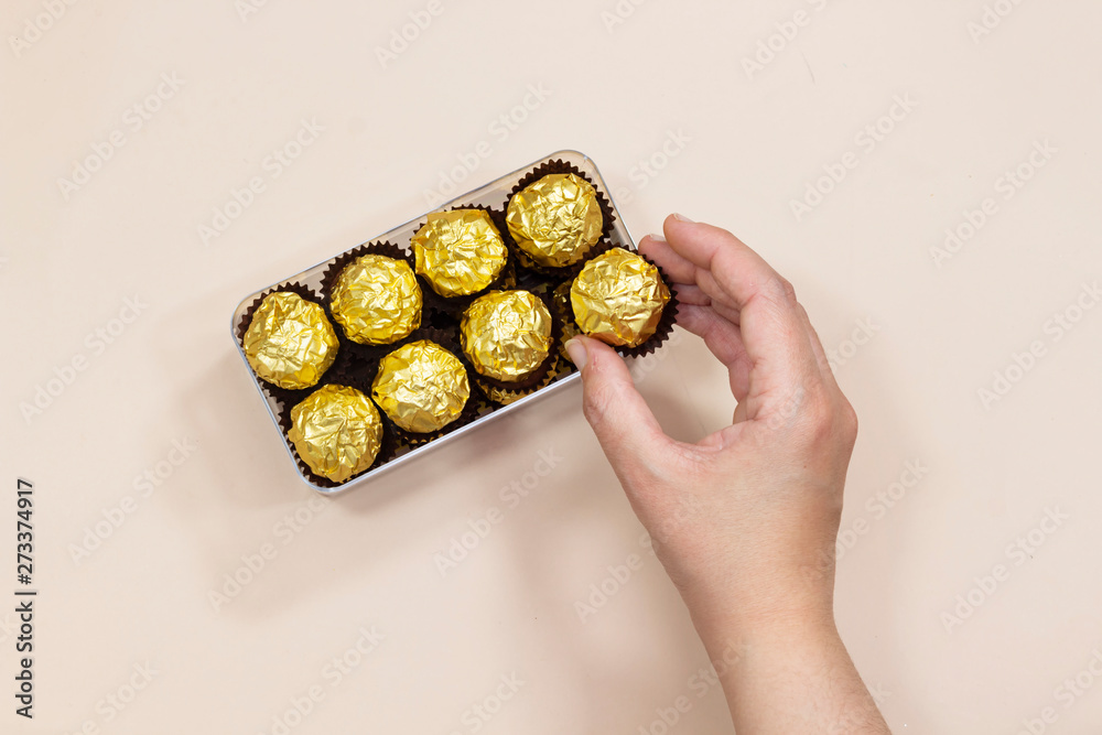 women hand holding golden premium chocolate sweets Stock Photo | Adobe ...