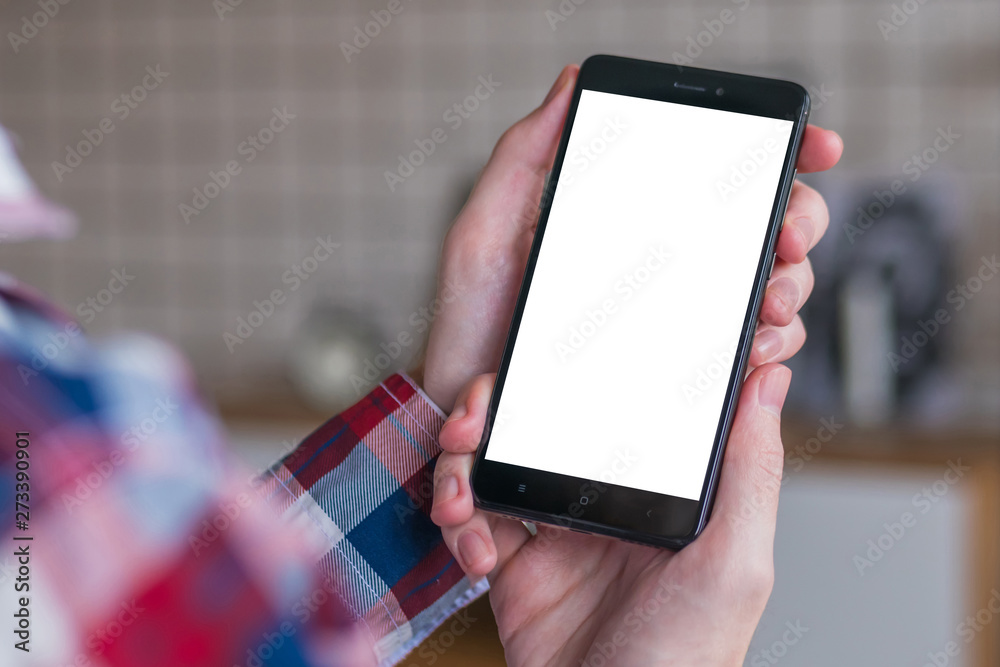 Mockup image: man looking at black smartphone with white blank screen ...