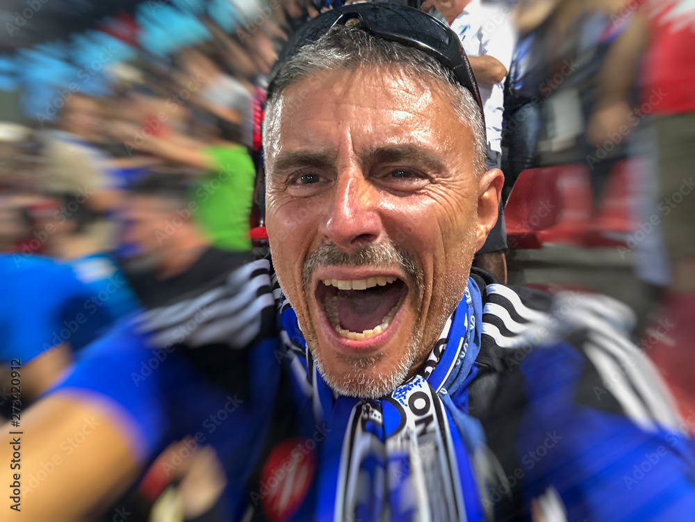 Boundless happiness of male supporter in the stadium after a final ...