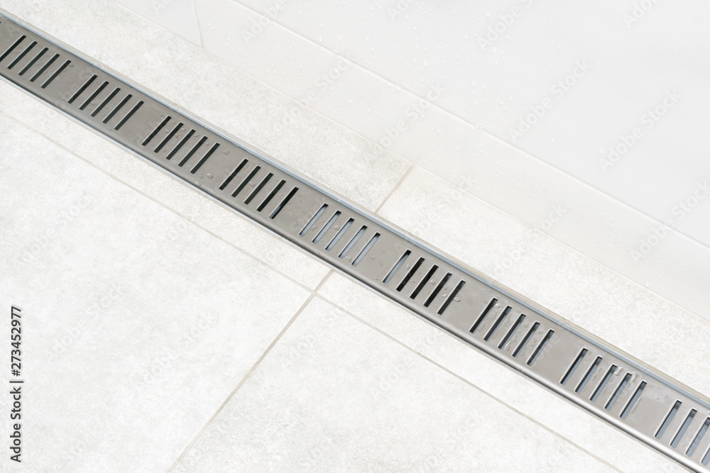 Linear shower drain system with steel grate. Drainage at bathroom Stock ...