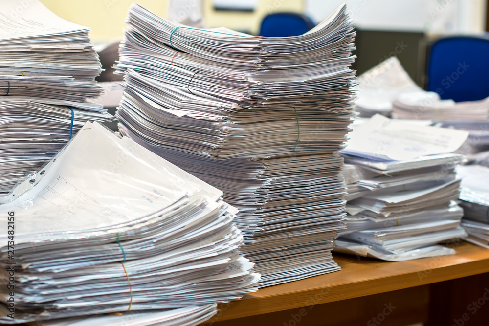 bundles bales of paper documents. stacks packs pile on the desk in the ...
