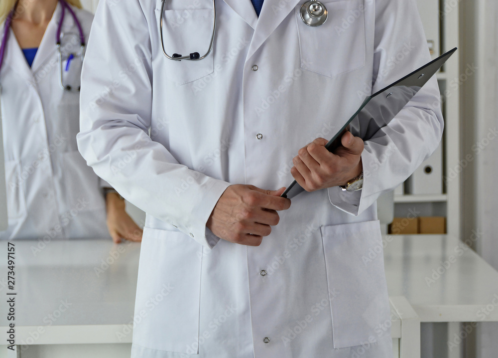 Medical doctor in white uniform with a clipboard and stethoscope. Male ...