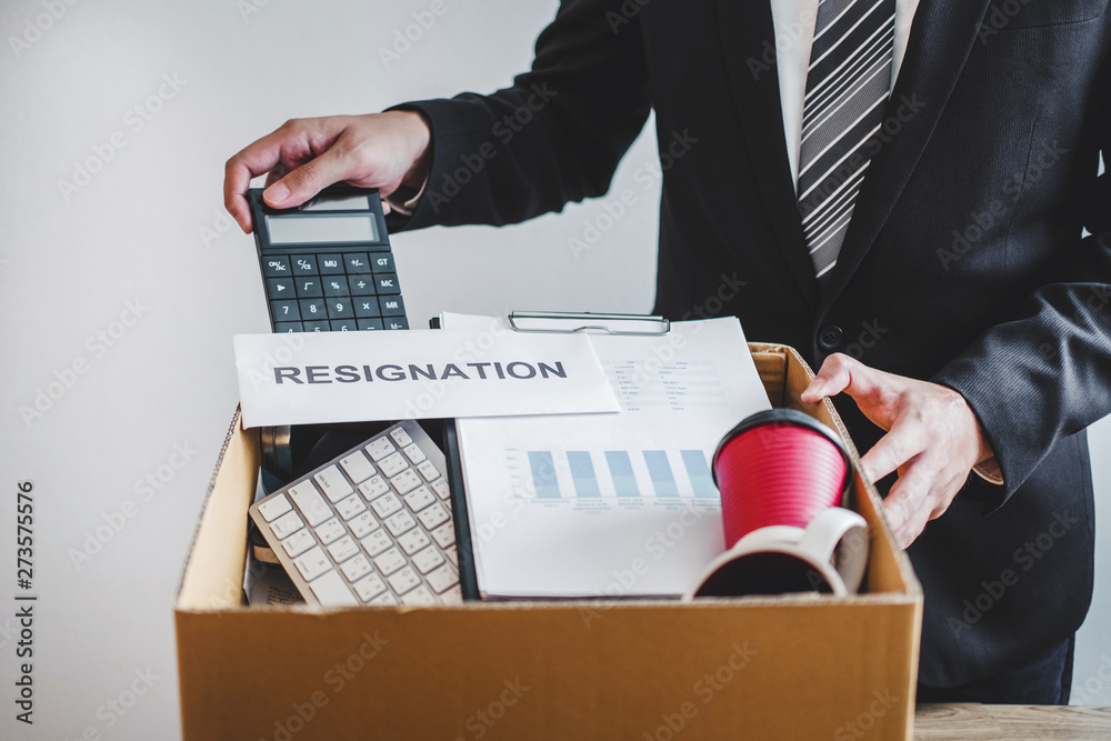 Business man stressing with resignation letter for quit a job packing ...