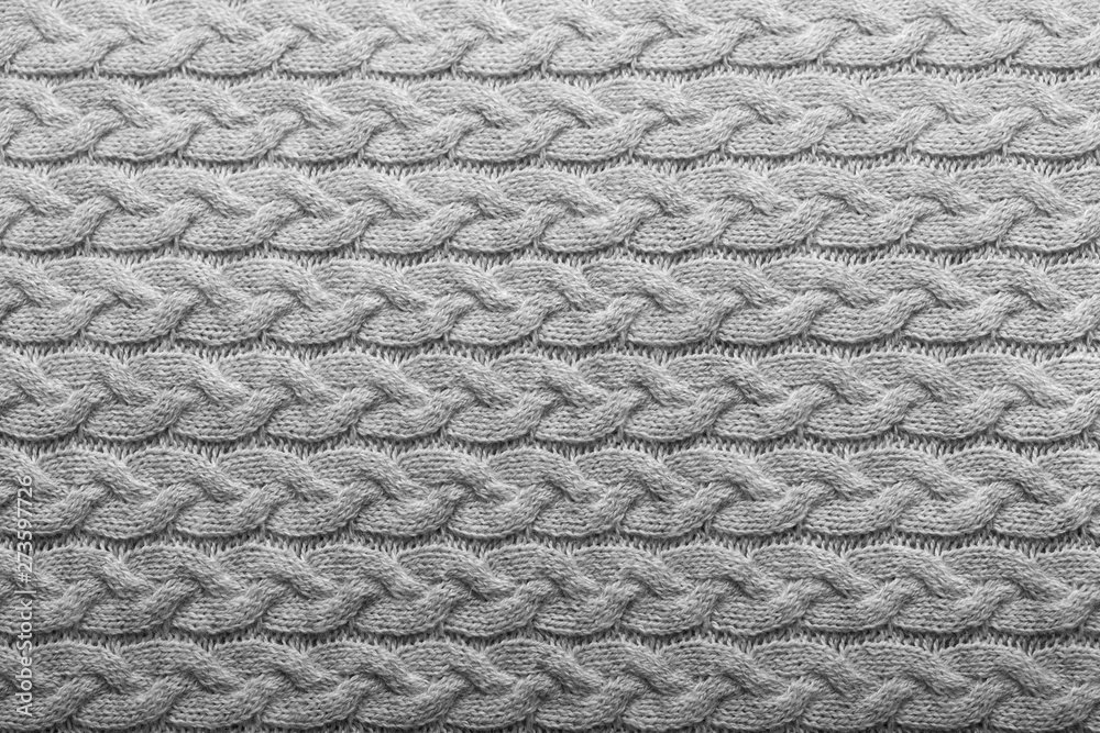 Light grey knit fabric background with horizontal cable pattern, wool ...