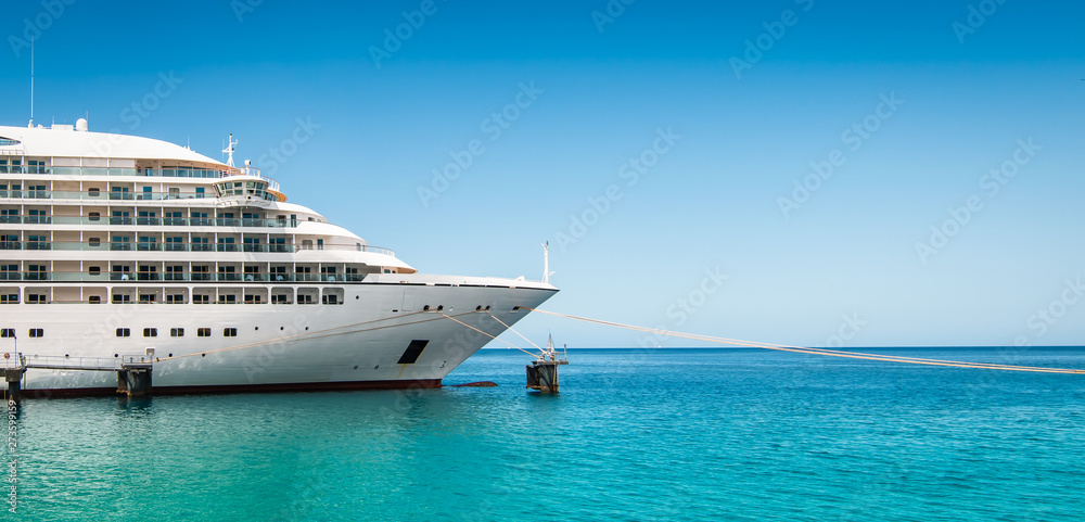 Side view and bow of a docked cruise ship on a summer day with clear ...