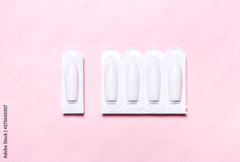 suppository on a pink background, for the treatment of hemorrhoids ...