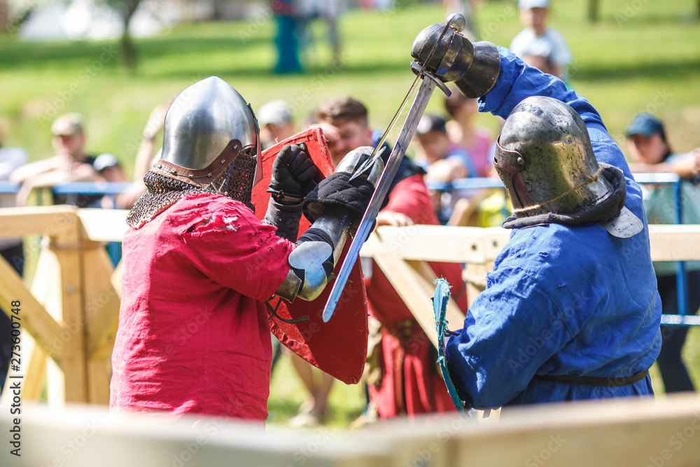 medieval jousting knight fight, in armor, helmets, chain mail with axes ...