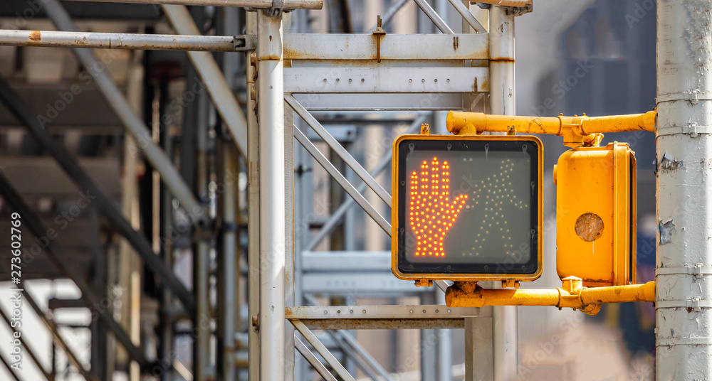 Stop, dont walk traffic sign for pedestrians, blur construction site ...