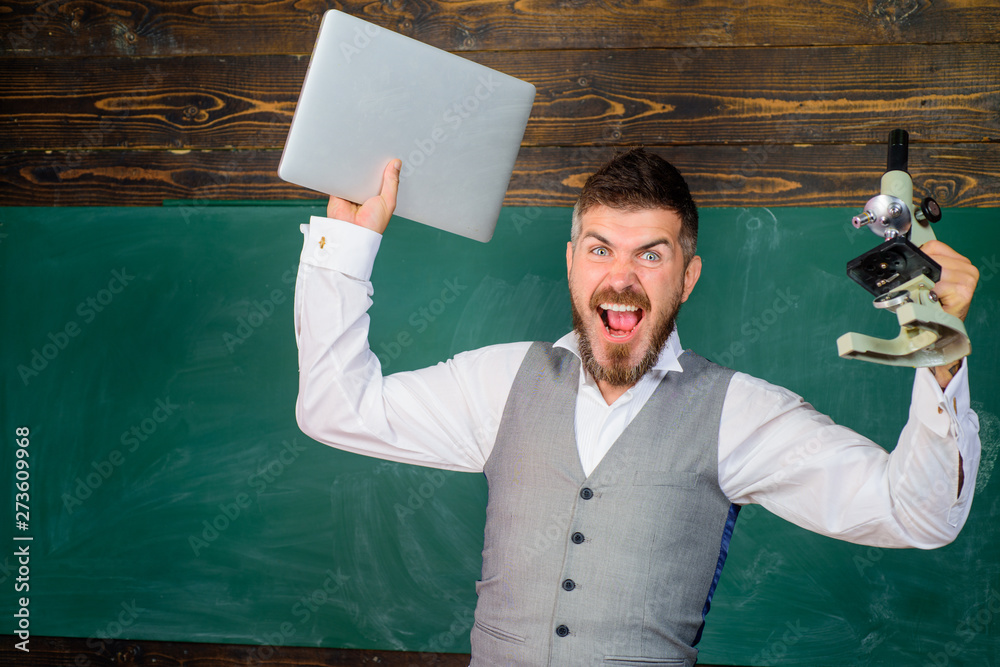 Foto de Angry scientist with laptop and microscope. Bearded man with ...