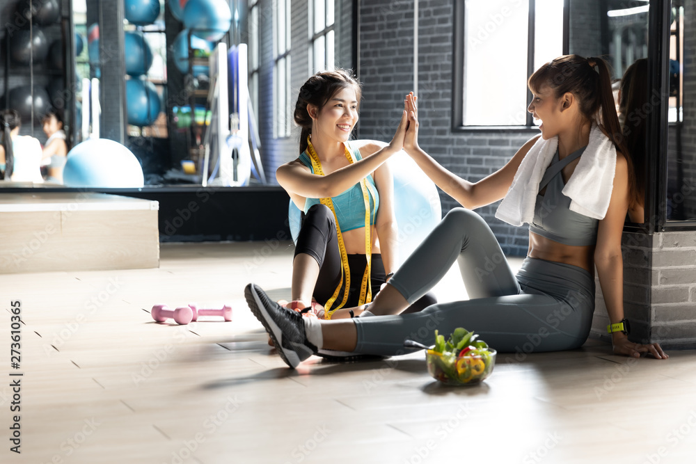 Healthy asian two people young woman making high five gesture in gym ...
