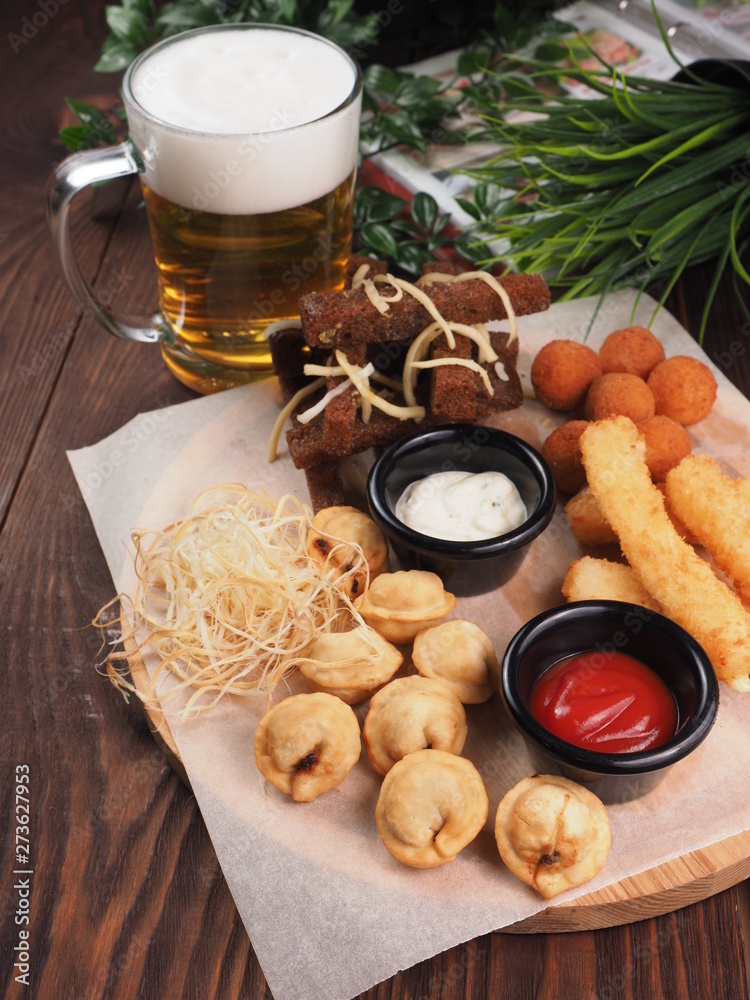 Big set of snacks for beer it includes fried cheese balls, pigtail ...