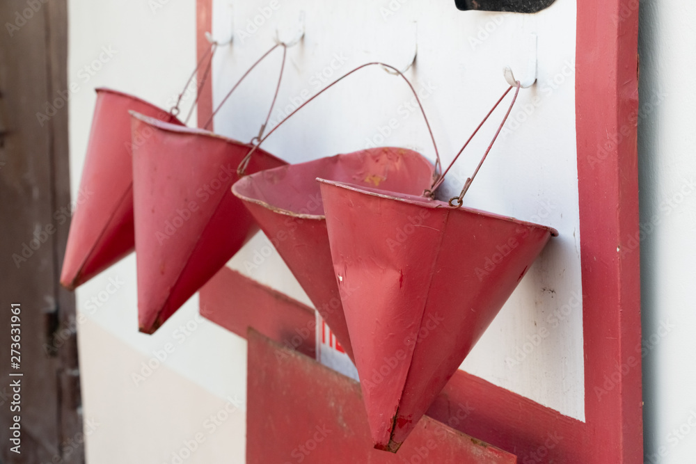 red bucket to fight the fire. a red bucket is hanging on a fire shield ...