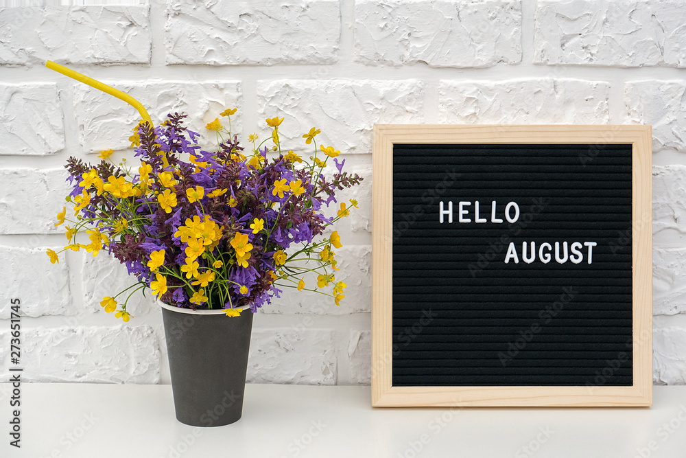 text Hello August on black letter board and bouquet of colored flowers ...