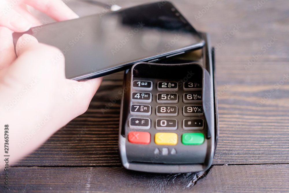 POS terminal, Payment Machine with mobile phone on store background ...