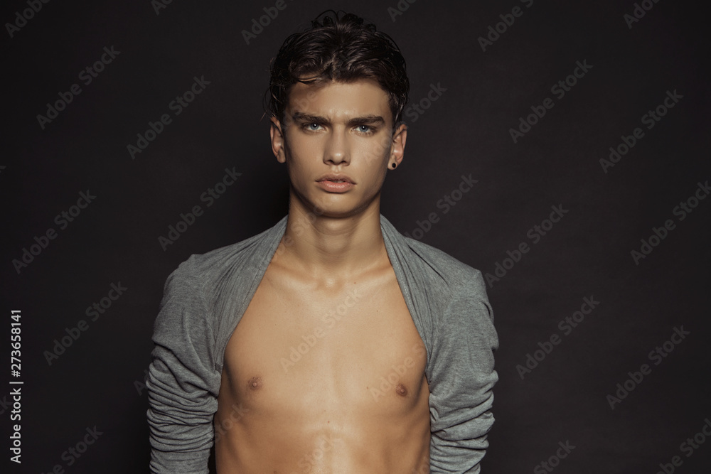 Strong stripped muscle male model in grey underwear and grey jamper and ...