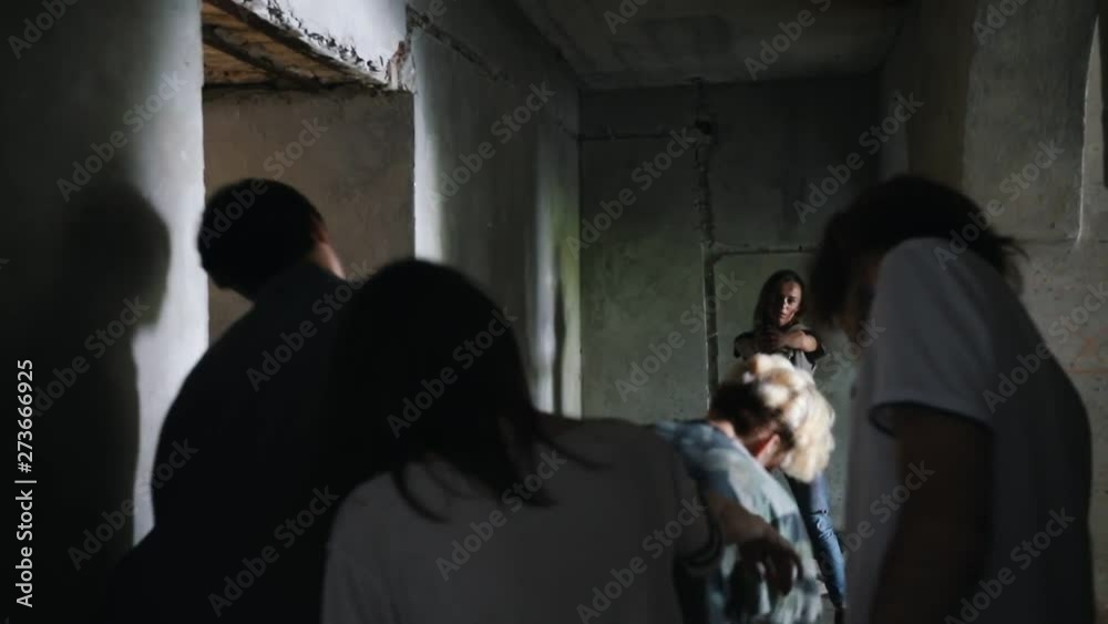 A zombie apocalypse. Survived woman with a gun walking out from the ...
