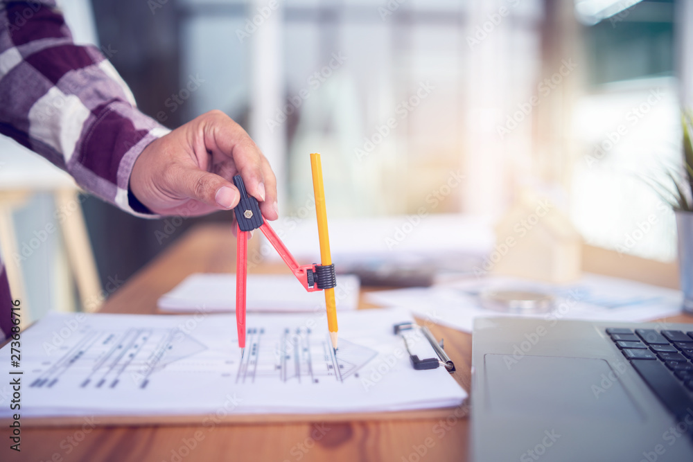Architect working on blueprint with Circus.engineer inspective in ...