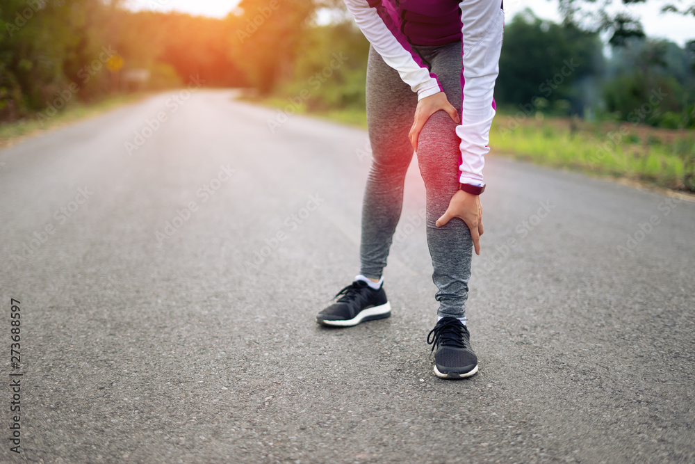 sport runner woman cramps in leg and feel pain, athletic young Asian ...