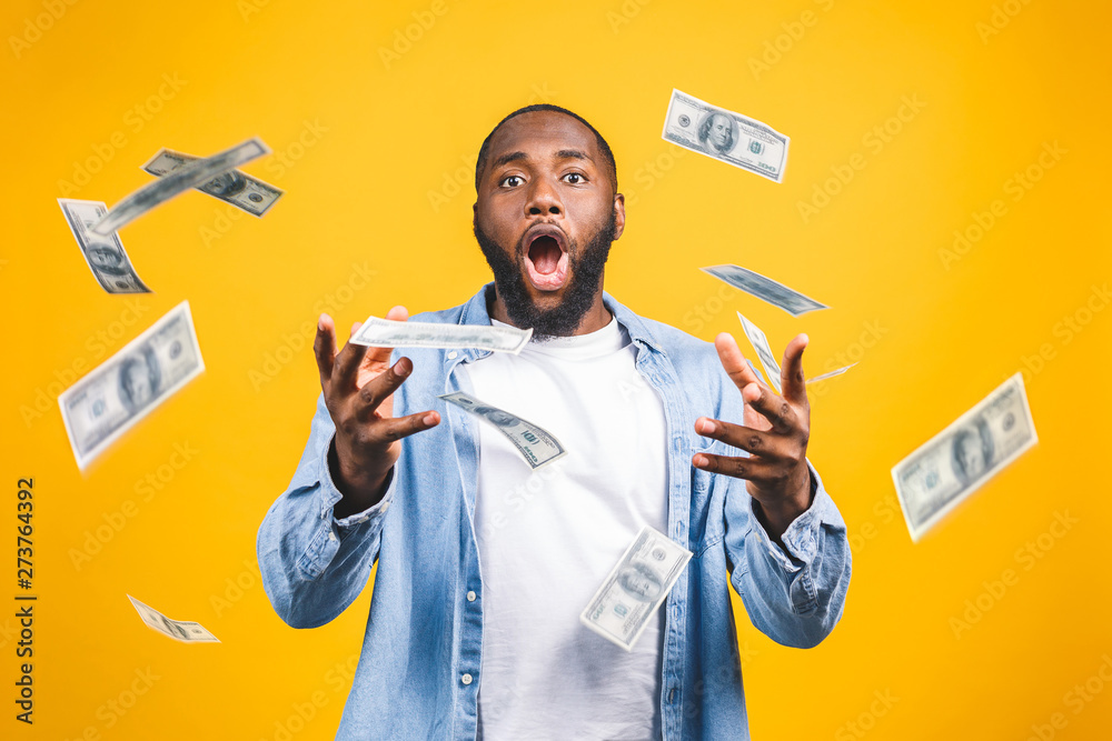 Portrait of a happy young afro american man throwing out money ...