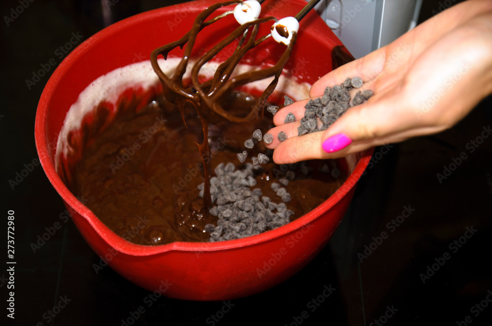 the process of making chocolate brownie cake. the girl adds with the ...