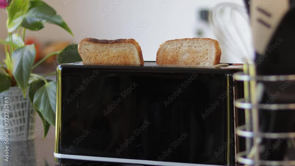 toast jumping out of black modern toaster in fancy kitchen with props ...