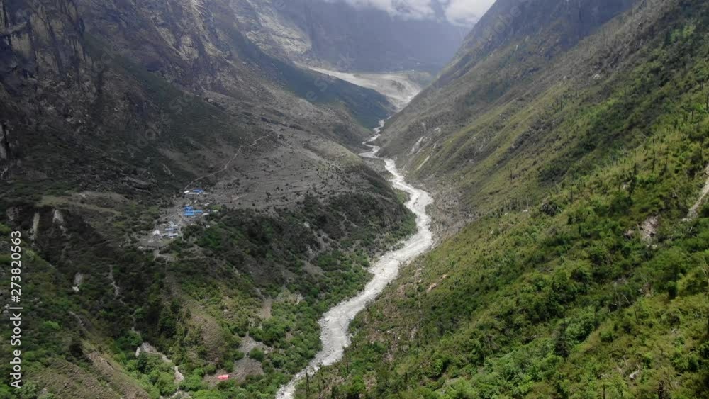 Aerial descent with approach showing the large Langtang valley in Nepal ...