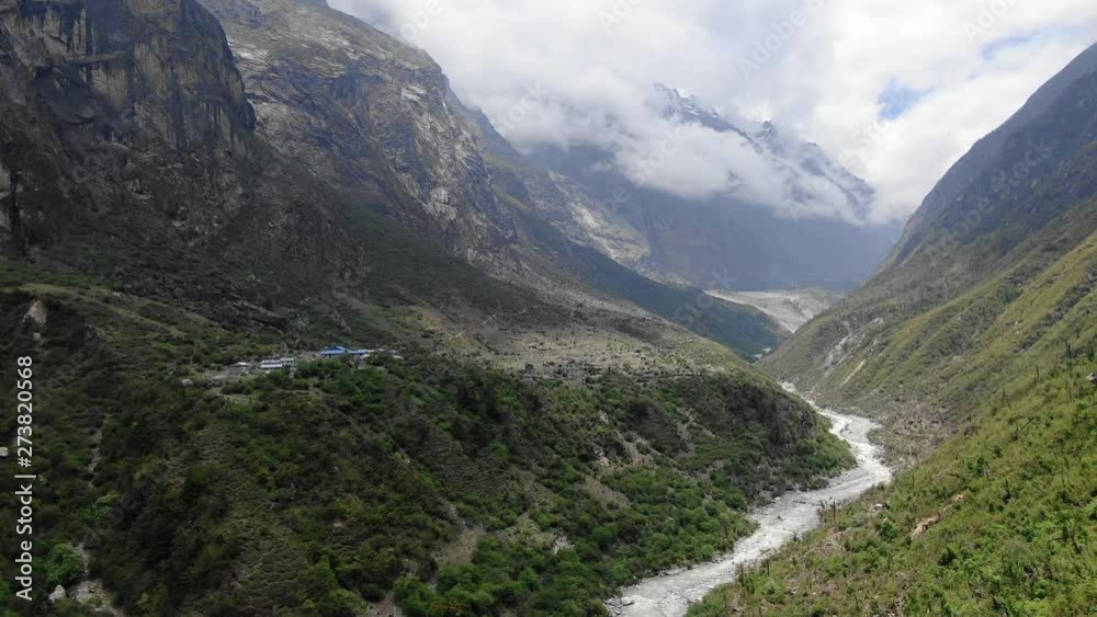 Aerial ascent showing a small Himalayan village in Nepal with large ...