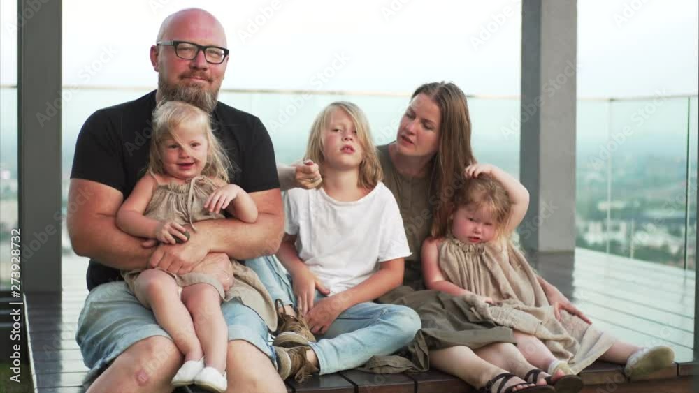 Caucasian family: parents, two adorable daughters and son are posing on ...