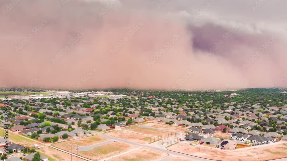 4K Ariel pan footage of a giant dust storm or haboob approaching a ...