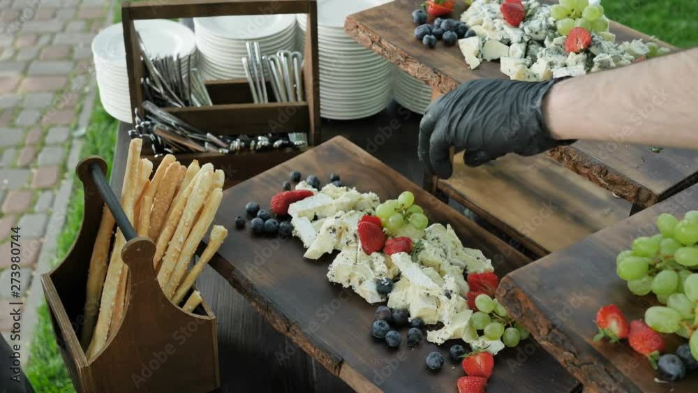 Decorating a cheese station at a corporate party or a wedding.Station ...