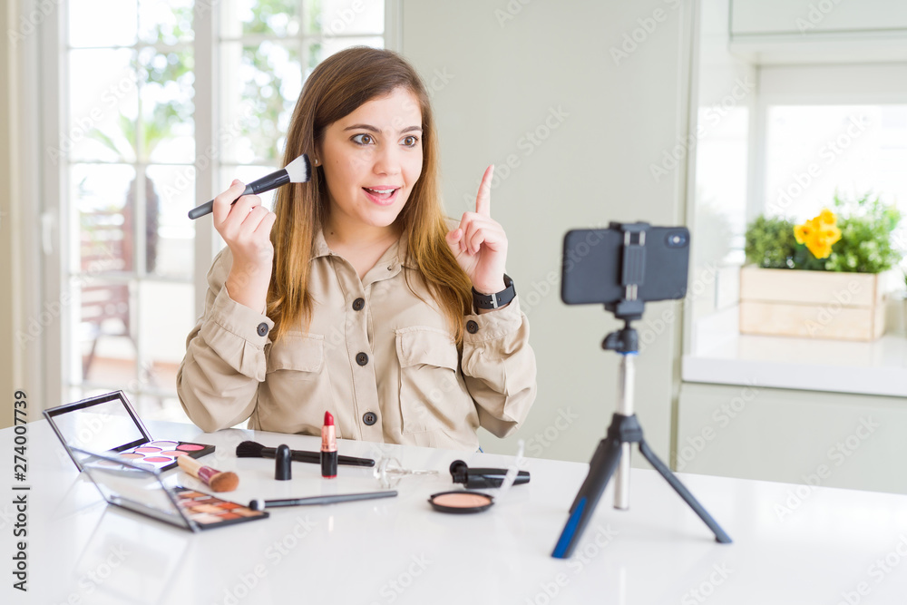 Beautiful young influencer woman recording make up video tutorial ...