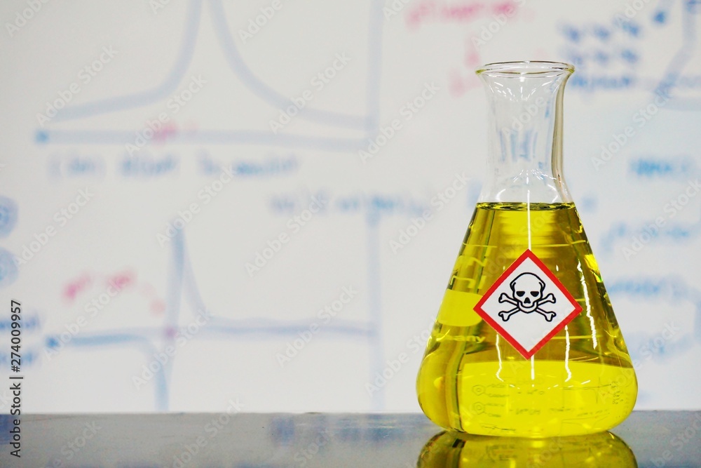 Erlenmeyer flask with Yellow liquid and chemical hazard warning symbols ...