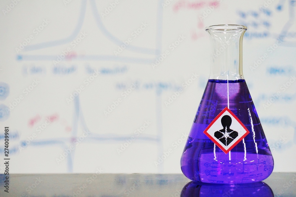 Erlenmeyer flask with Violet liquid and chemical hazard warning symbols ...