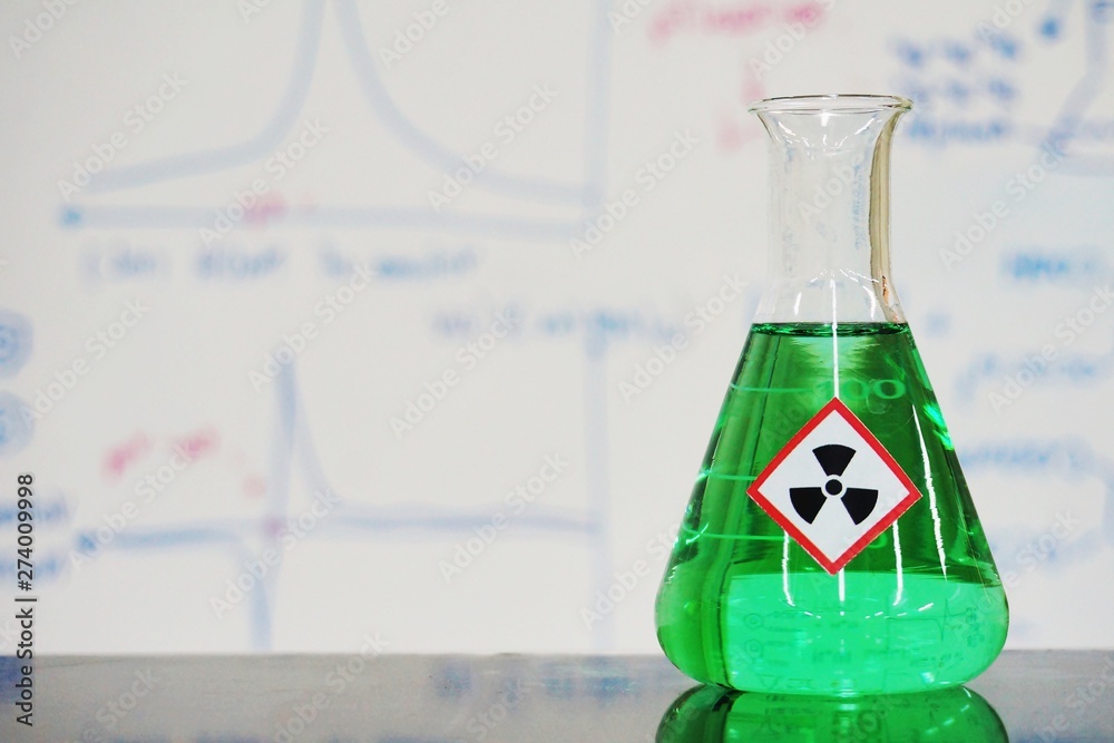 Erlenmeyer flask with Green liquid and chemical hazard warning symbols ...
