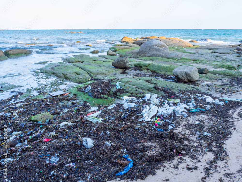 Garbage on the beach. Spilled garbage on the beach of the big city ...